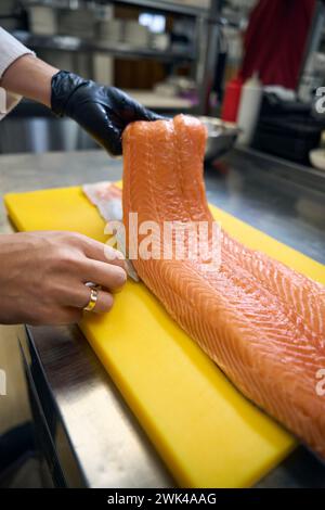 Professional man cuts red fish with a sharp knife Stock Photo - Alamy