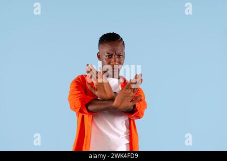 woman in orange shirt crossing hands and palms in refusal negative ...