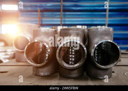 Batch of T shape pipe parts in factory Stock Photo - Alamy