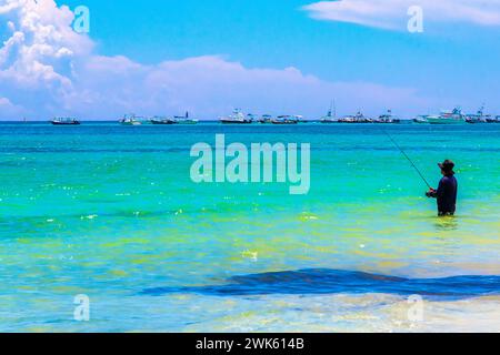 Mexican fisher angler with fishing rod on the Caribbean Sea beach in ...