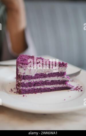cutting A piece of purple velvet cake with cream Stock Photo - Alamy