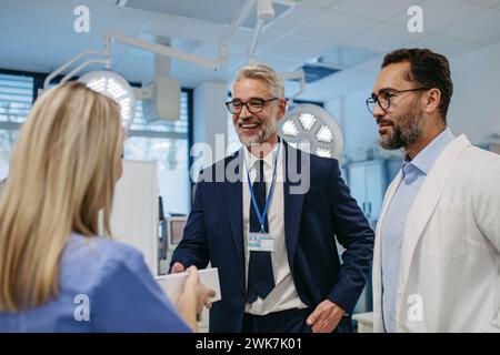 Pharmaceutical sales representative talking with female doctor in ...