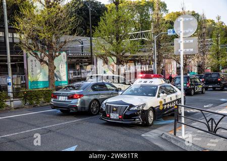 Harajuku ward in Tokyo, early evening and Tokyo police officers patrol ...