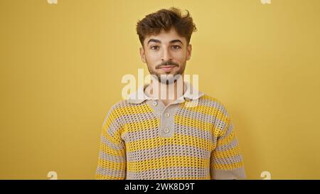 Stylish young arab man coolly bears his serious expression, standing ...