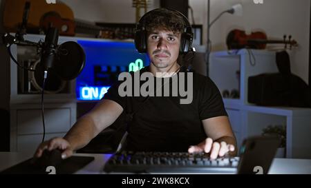 Young hispanic man streamer playing video game using smartphone at ...