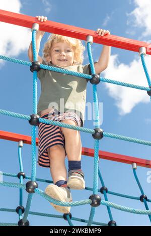 A little boy walks on a rope bridge Stock Photo - Alamy