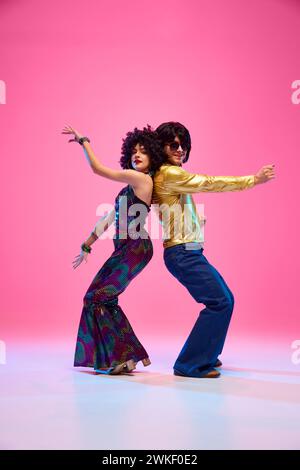 Energetic disco dance lift, couple in 1970s fashion outfit dancing in ...