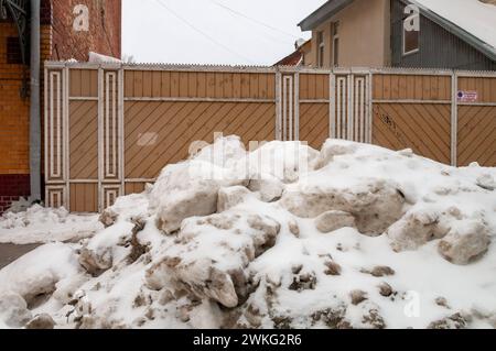 Consequences of snowfall A huge mountain of snow on the roadway Samara ...