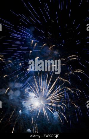 Blue festive fireworks and explosions at night over black Stock Photo ...