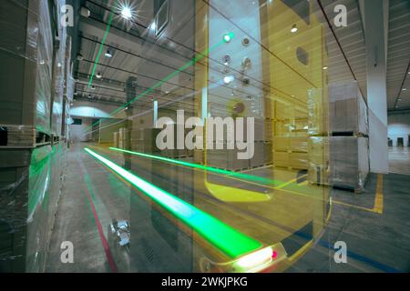 Light trails inside an automated warehouse where shipments are ...