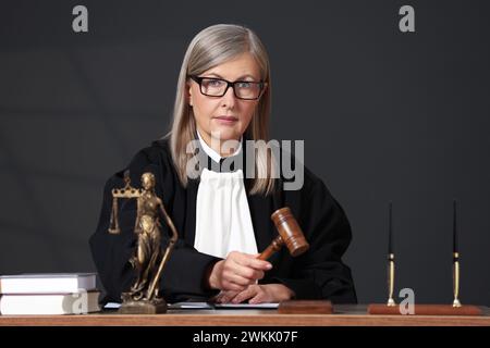 Judge striking wooden mallet at table indoors Stock Photo - Alamy