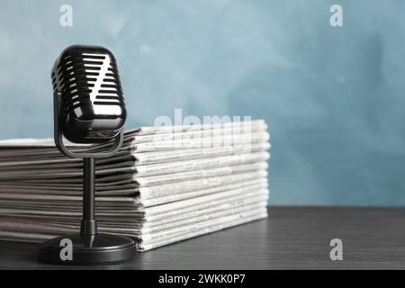 Newspapers and vintage microphone on table. Journalist's work Stock ...