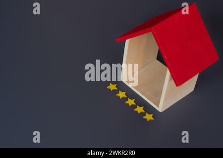 Toy house and five stars rating. Copy space for text. Real estate and ...