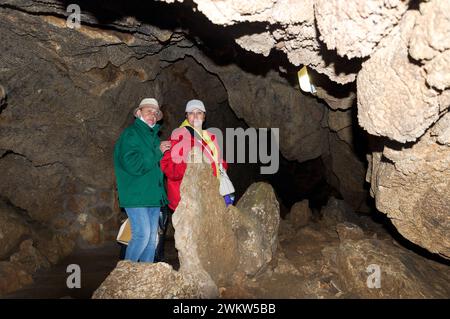 Two women, members of the tourist group, pose against the backdrop of ...