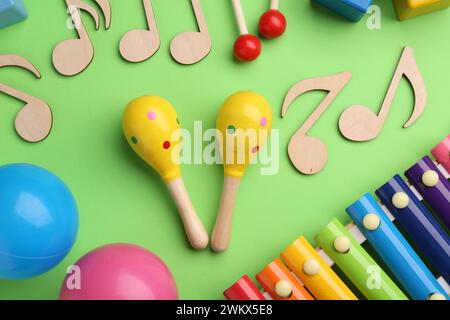 Tools for creating baby songs. Flat lay composition with maracas on green background Stock Photo ...