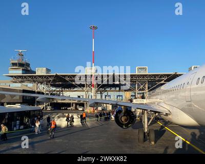 Passengers boarding a shuttle bus from Pegasus airplane to airport on ...