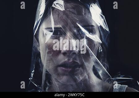 Scary, face and woman with plastic or bag in horror, drama or death in ...
