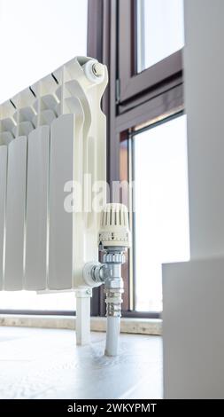 White big radiator near window in modern room Stock Photo - Alamy