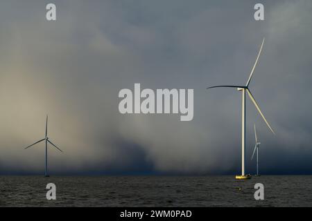 Netherlands, Flevoland, Lelystad, Thick clouds over offshore wind farm ...