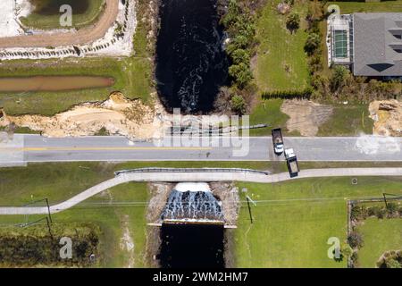 Construction trucks blocking road access at destroyed bridge after ...