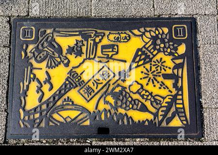 Kobe, Japan, manhole cover. Fire Hydrant access cover. Circular, yellow ...