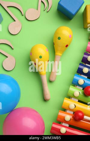 Tools for creating baby songs. Flat lay composition with maracas on green background Stock Photo ...