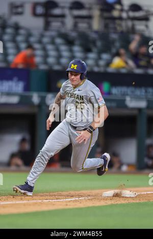 February 23, 2024: Michigan base runner Jonathan Kim #21 glances over ...