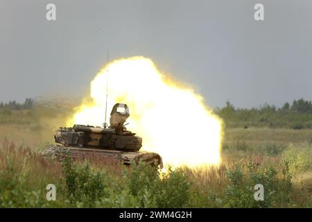 Fire and smoke from a tank shot during training at the training ground ...