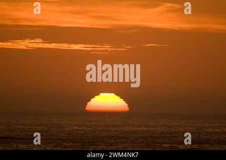 Sunsetting green flash with clouds from the eastern horizon as seen ...