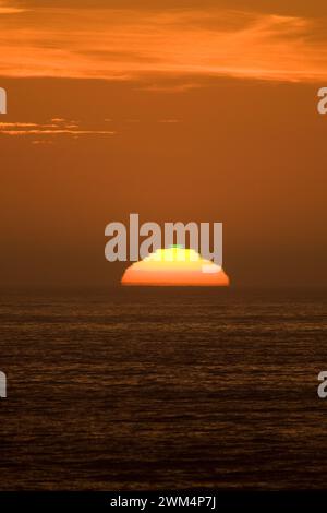 Sunsetting green flash with clouds from the eastern horizon as seen ...