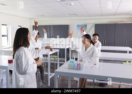Diverse students engage in a science experiment at high school Stock ...