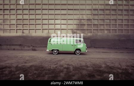 side view green volkswagen bus kombi decorated with rainbow pennants at ...