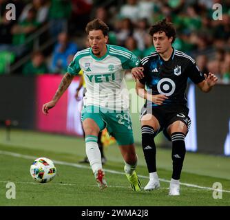 Austin FC defender Guilherme Biro, left, tries to head in the ball ...