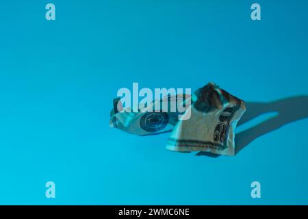 Damaged and marked twenty dollar bill on a blue background Stock Photo ...