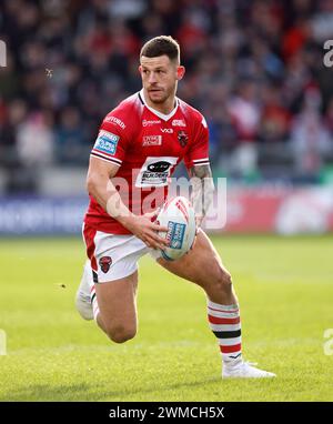 Cade Cust of Salford Red Devils holds his shoulder after a tackle ...