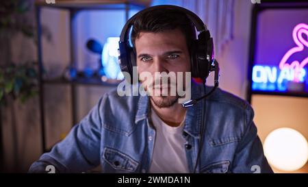 Hispanic man with beard wearing gamer hat and headphones pointing to ...