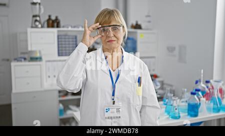 Middle age woman wearing scientist unifor and medical mask working at ...