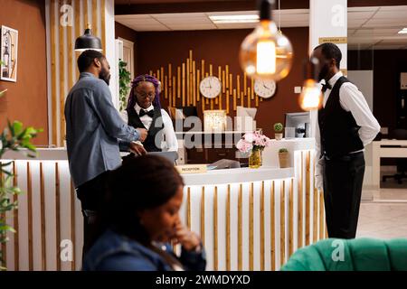 friendly hotel receptionist welcoming female customer Stock Photo - Alamy