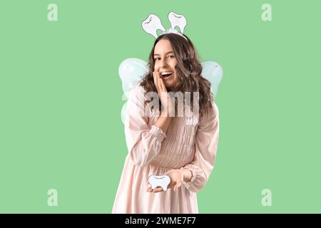 Tooth Fairy with paper figure on pink background Stock Photo - Alamy