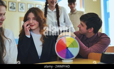 Students in physics class spin Newton's colorful wheel Stock Photo - Alamy