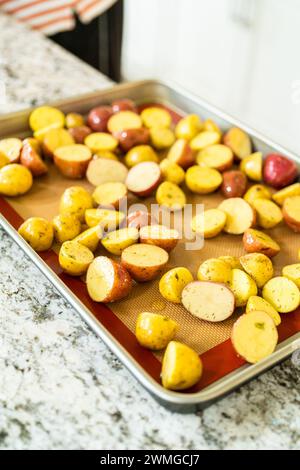Roasting Halved Mixed Marble Potatoes in Modern Kitchen Stock Photo - Alamy