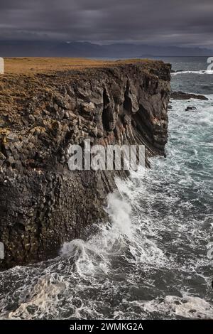 Lava cliffs along the seashore at Arnastapi, Snaefellsnes peninsula, on ...