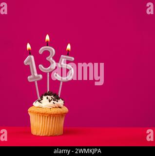 Cupcake with birthday candle - Candle number 135 Stock Photo - Alamy