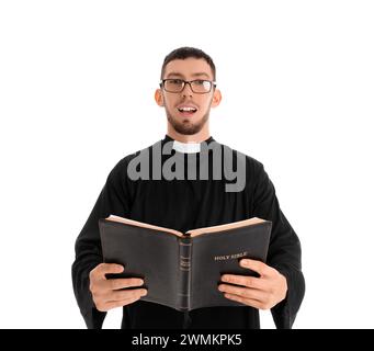 Young priest reading Holy Bible on white background Stock Photo - Alamy