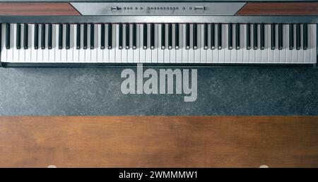 Piano keyboard on a dark marble and wood surface, top view Stock Photo ...
