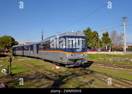 A diesel railcar of the OSE Greek railway leaving the main station in ...