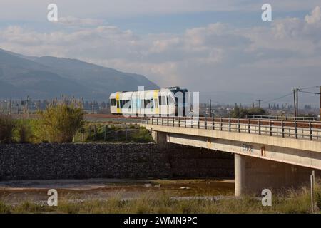 A diesel railcar of the OSE Greek railway leaving the main station in ...