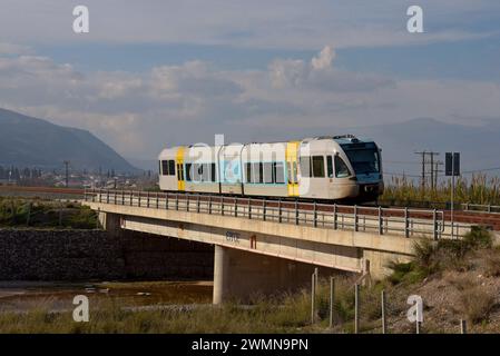 A diesel railcar of the OSE Greek railway leaving the main station in ...