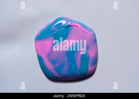 Colorful leaking paint liquid spills from close range Stock Photo - Alamy
