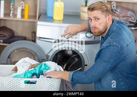 Young husband man doing laundry at home Stock Photo - Alamy